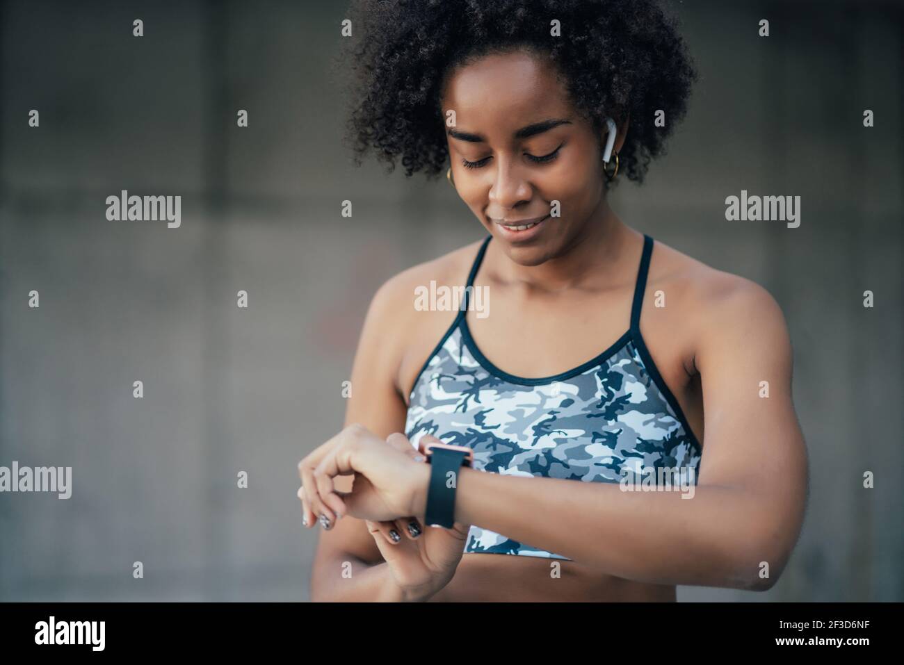 Fitness woman checking time on smart watch Stock Photo - Alamy