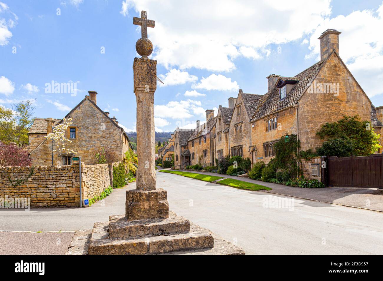 The old cross and sundial in the Cotswold village of Stanton ...