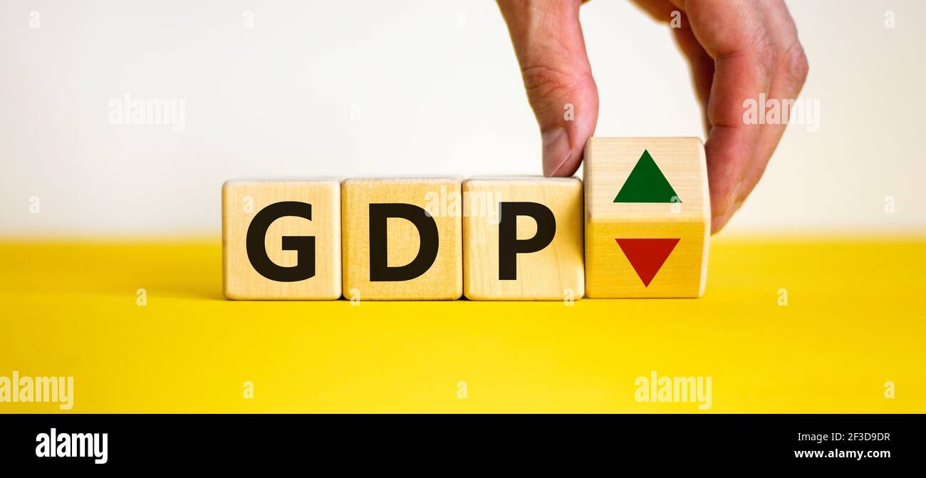 GDP, gross domestic product symbol. Businessman holds a cube with up ...