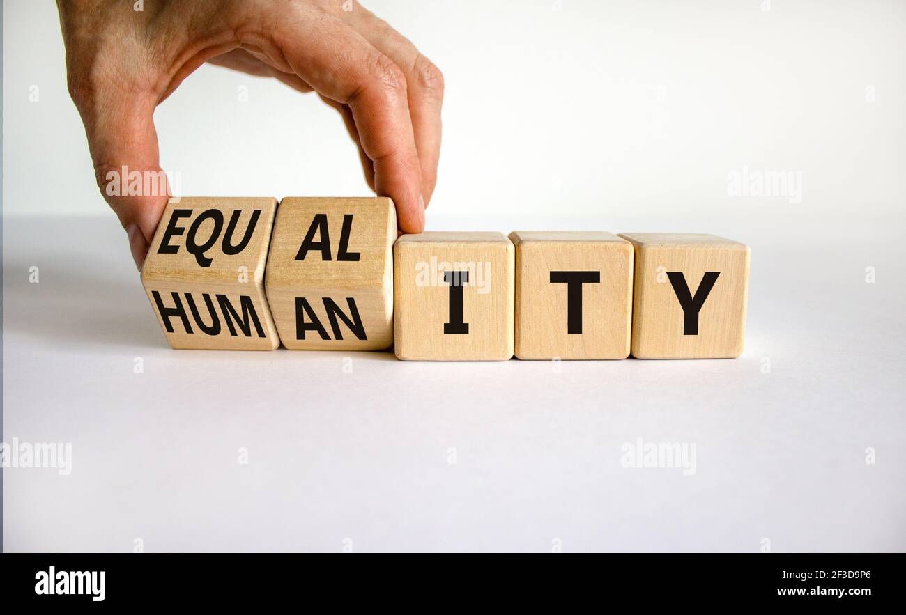 Equality and humanity symbol. Businessman turns wooden cubes and ...