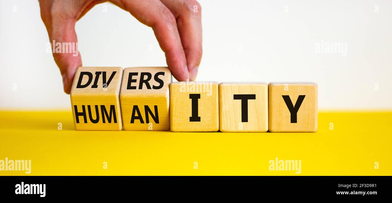 Diversity and humanity symbol. Businessman turns wooden cubes and ...