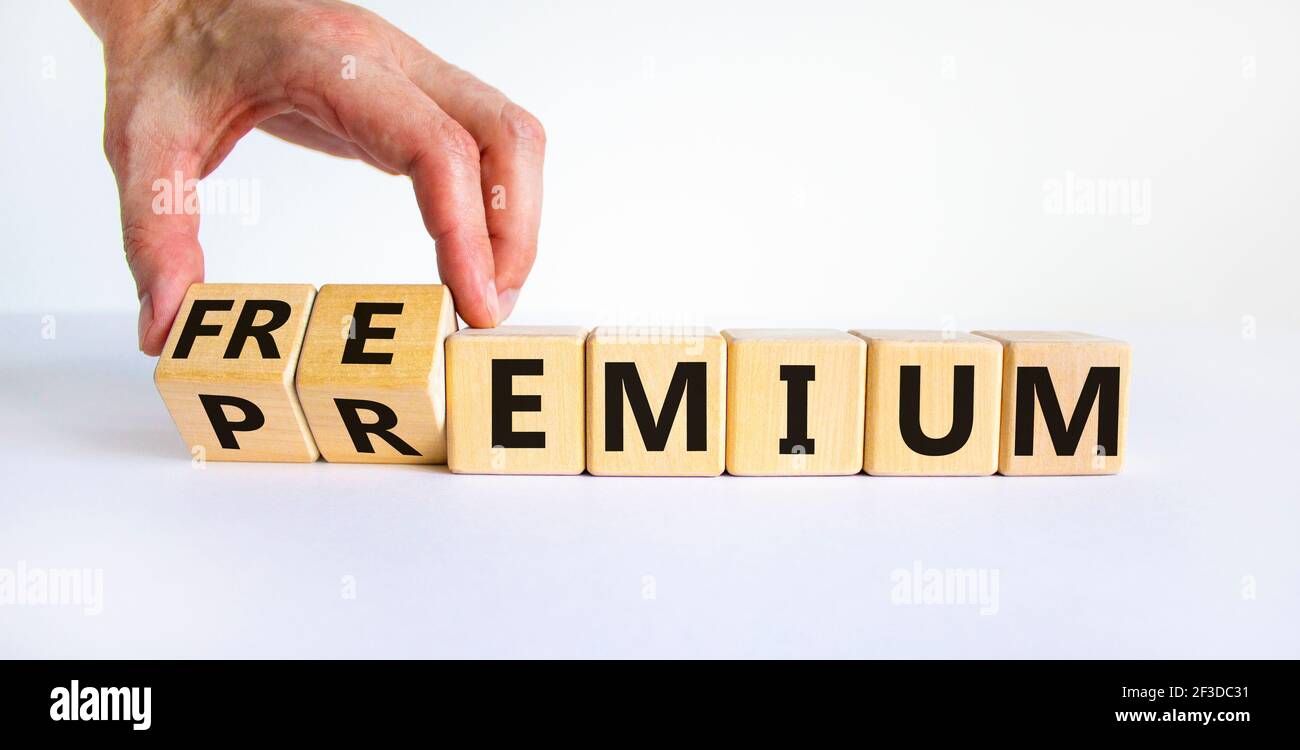 Premium or freemium symbol. Businessman turns wooden cubes and changes ...