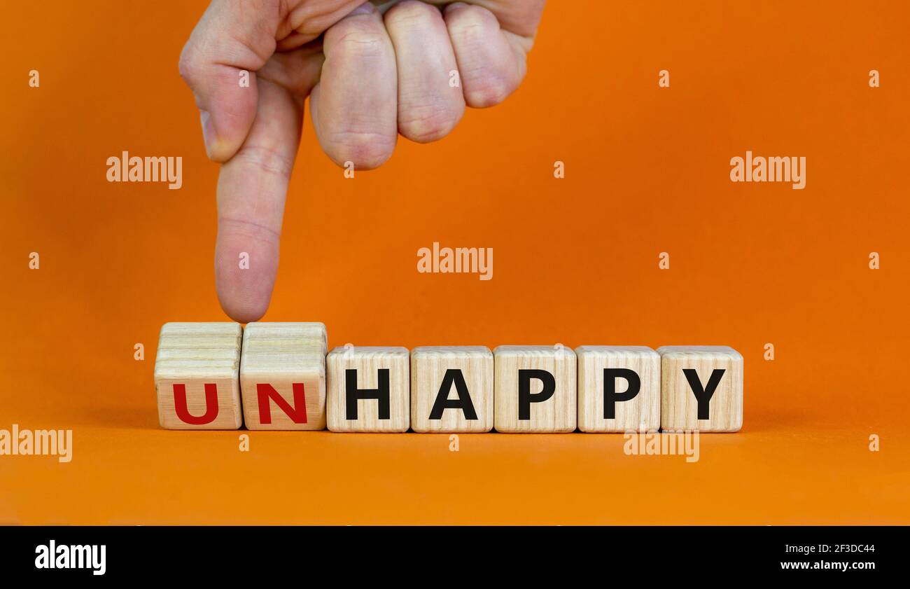 Be happy, do not unhappy symbol. Businessman turns wooden cubes and ...