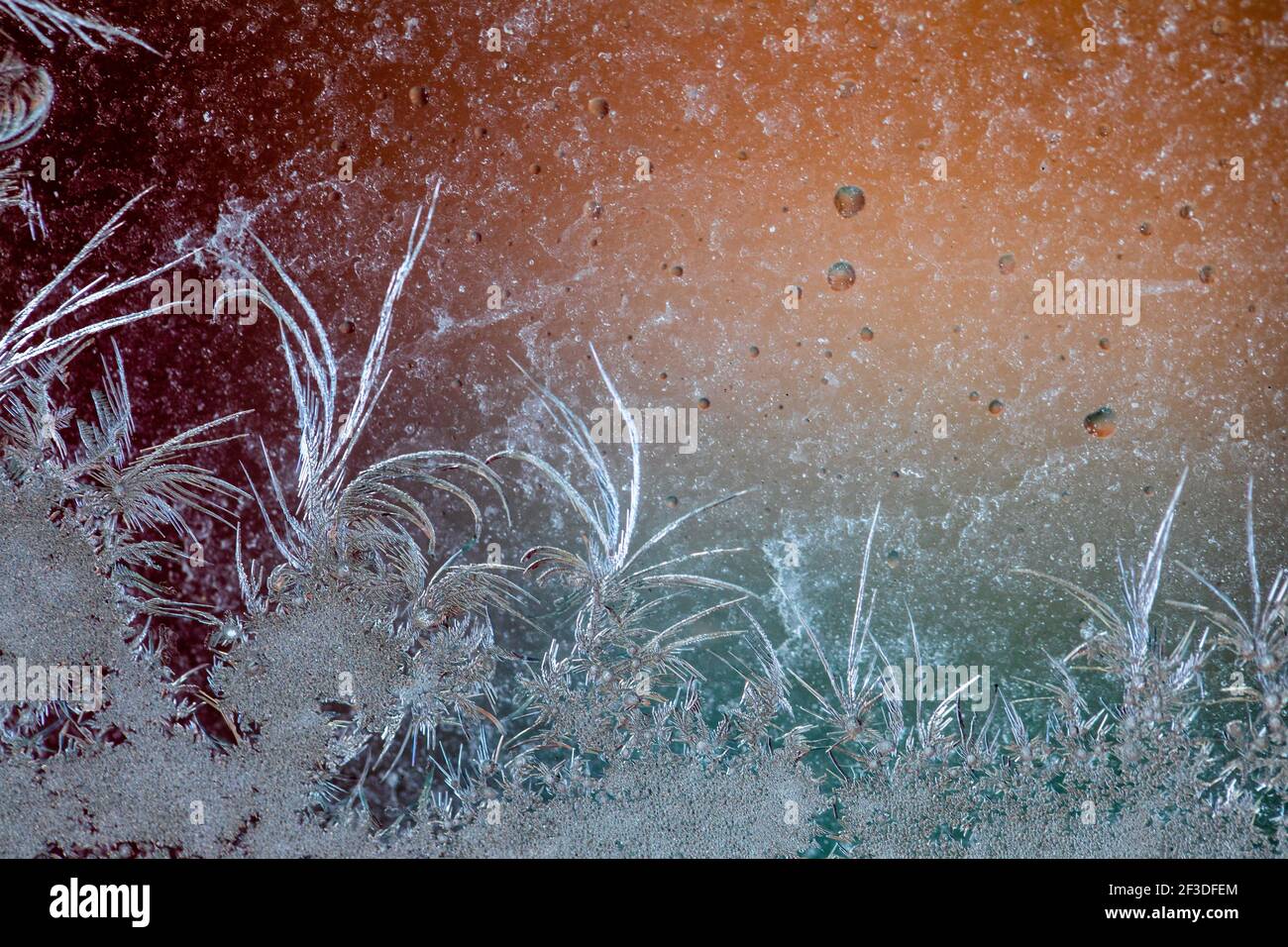 Jack Frost etchings on the window, with a colourful background Stock ...