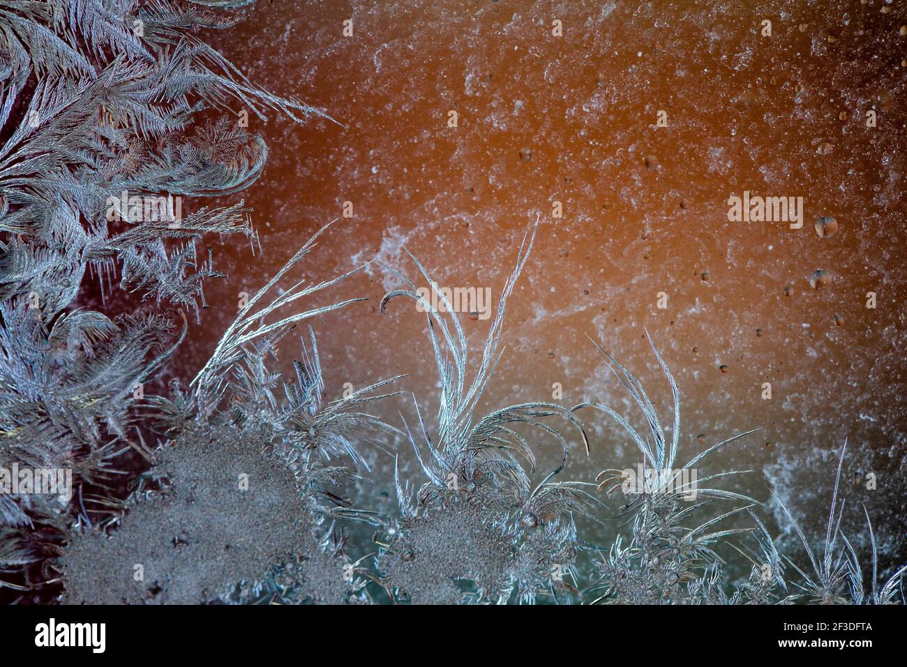 Jack Frost etchings on the window, with a colourful background Stock ...