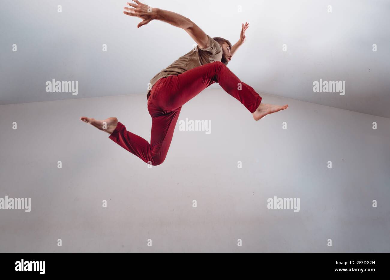 Muscular young guy practicing modern style dance poses Stock Photo - Alamy