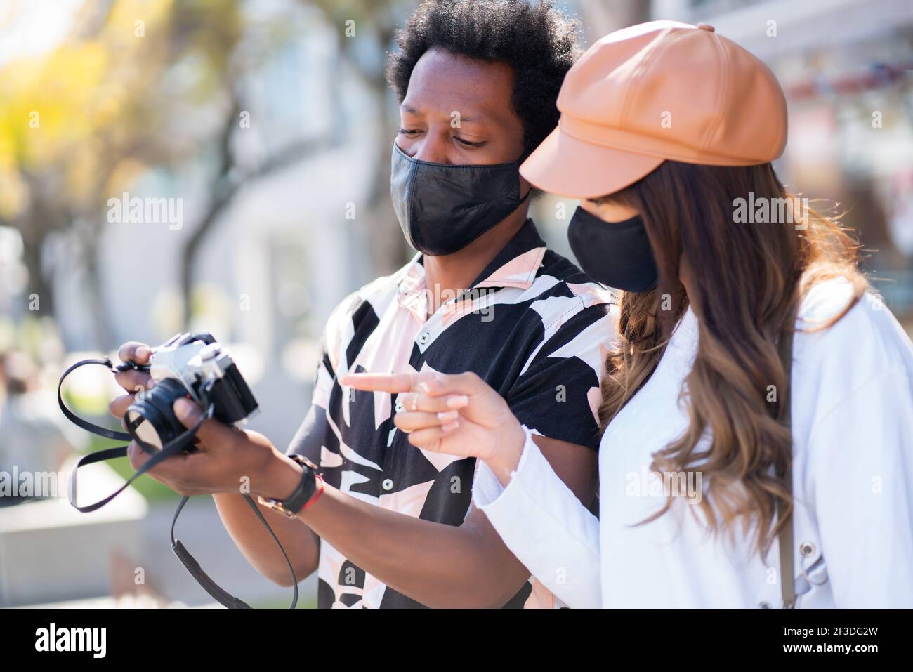 Tourist couple using camera outdoors Stock Photo - Alamy
