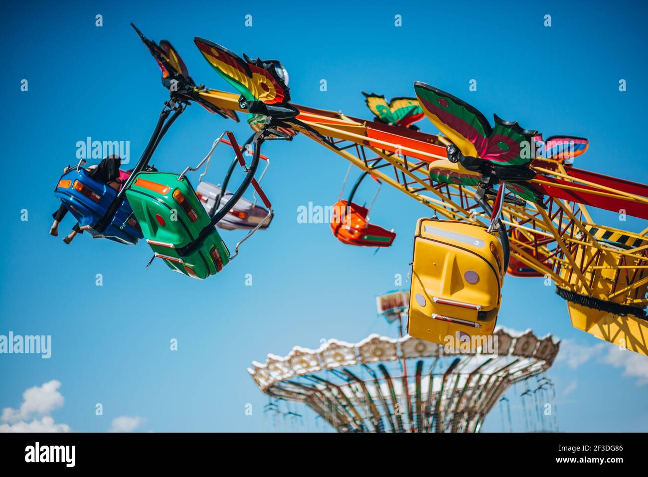 Shot of the colorful swinging carousel ride at an amusement park Stock ...