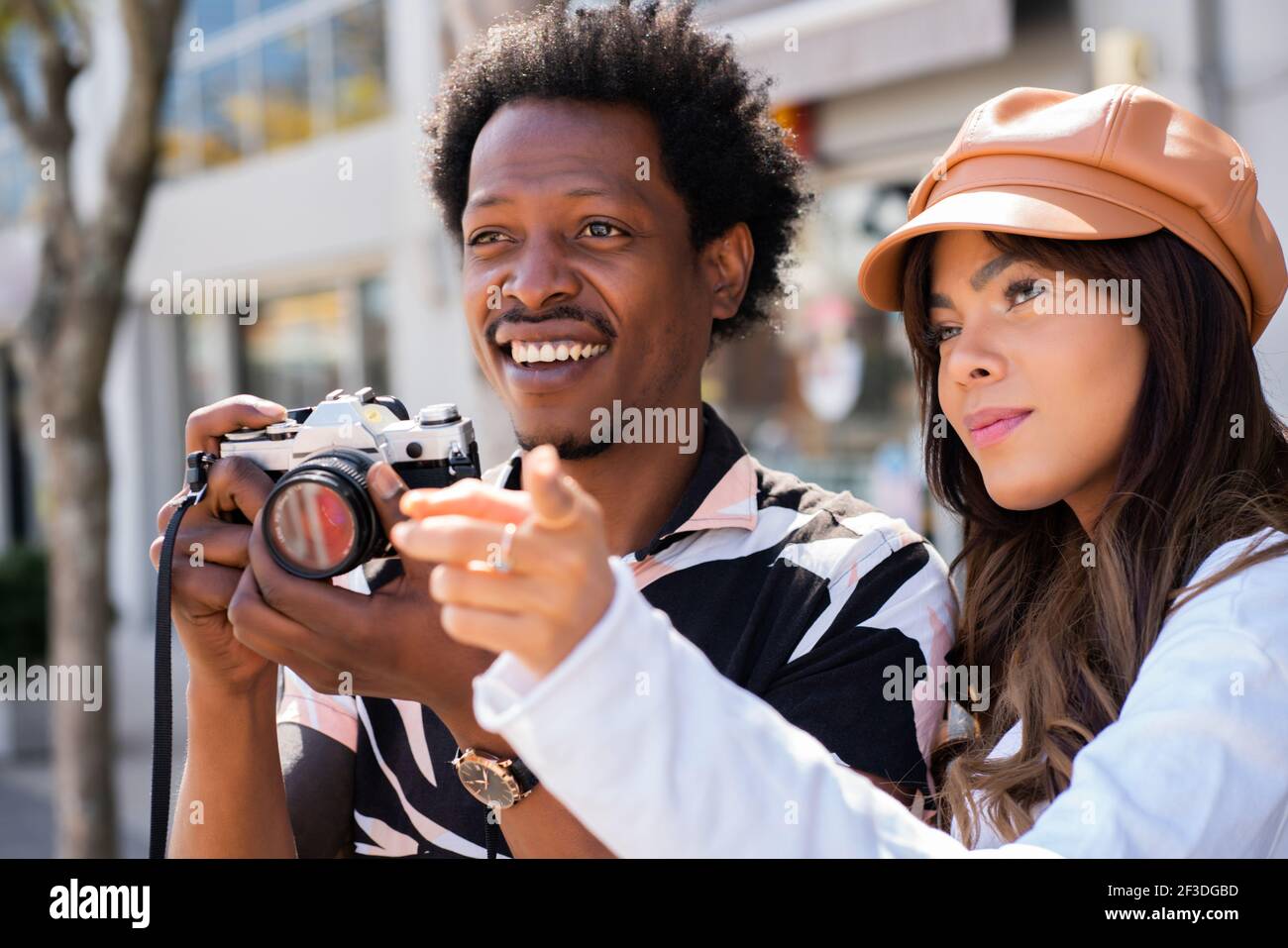 Tourist couple using camera outdoors Stock Photo - Alamy