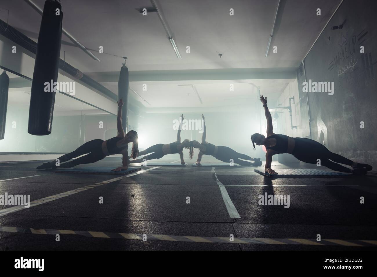 Women in black and white sportswear on a real group body Combat workout ...