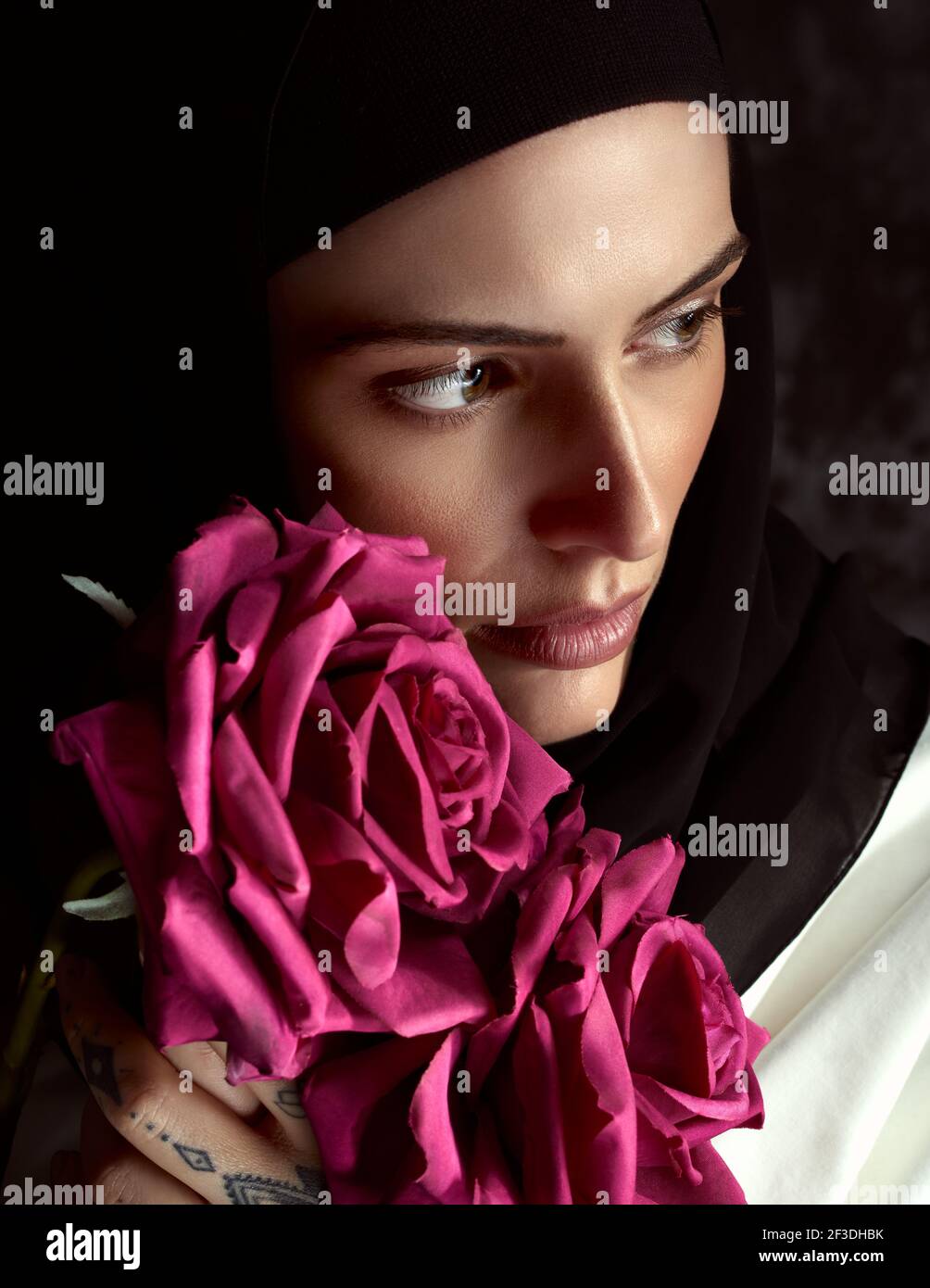 Artistic studio portrait with red roses of the ecstasy of a ...