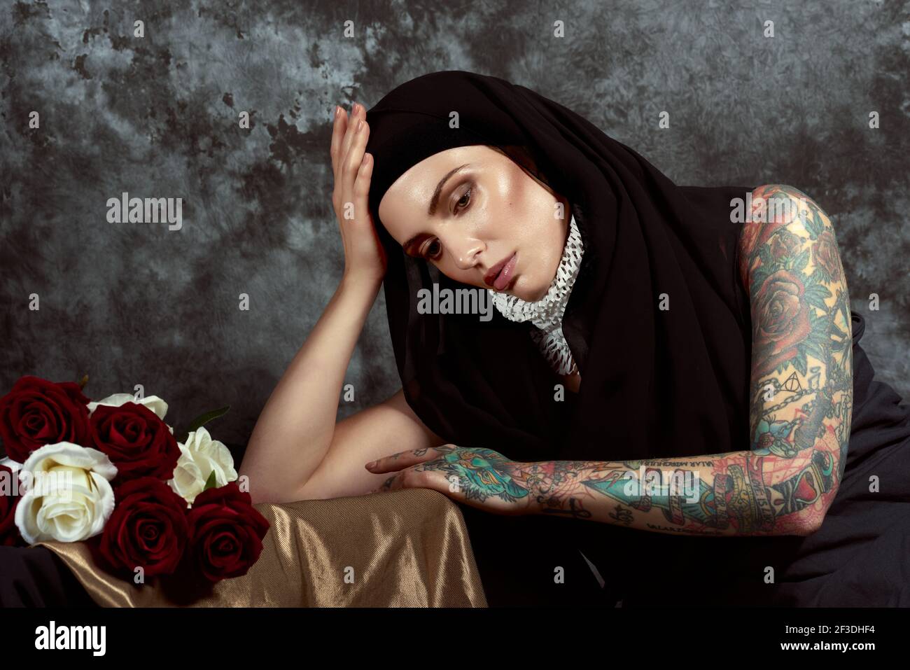 Artistic studio portrait with red roses and white flowers of the ...