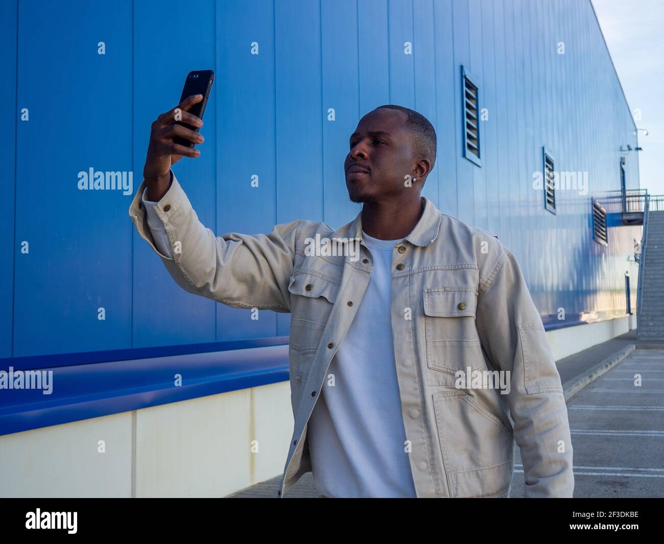 A handsome black Spanish male taking a selfie with his smartphone Stock ...