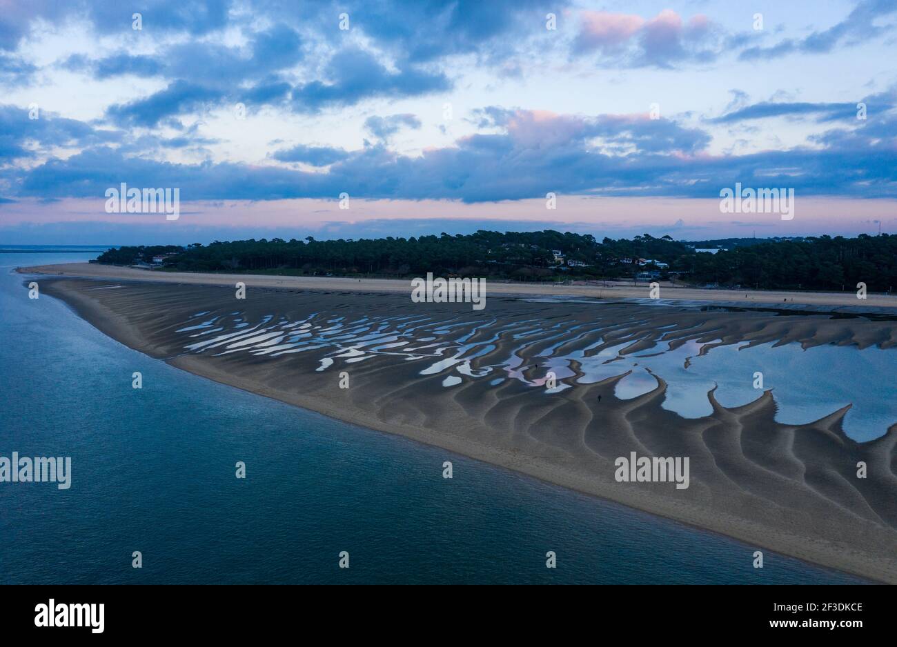 Drone view of sandy beach at low tide. Large water pools retained by ...