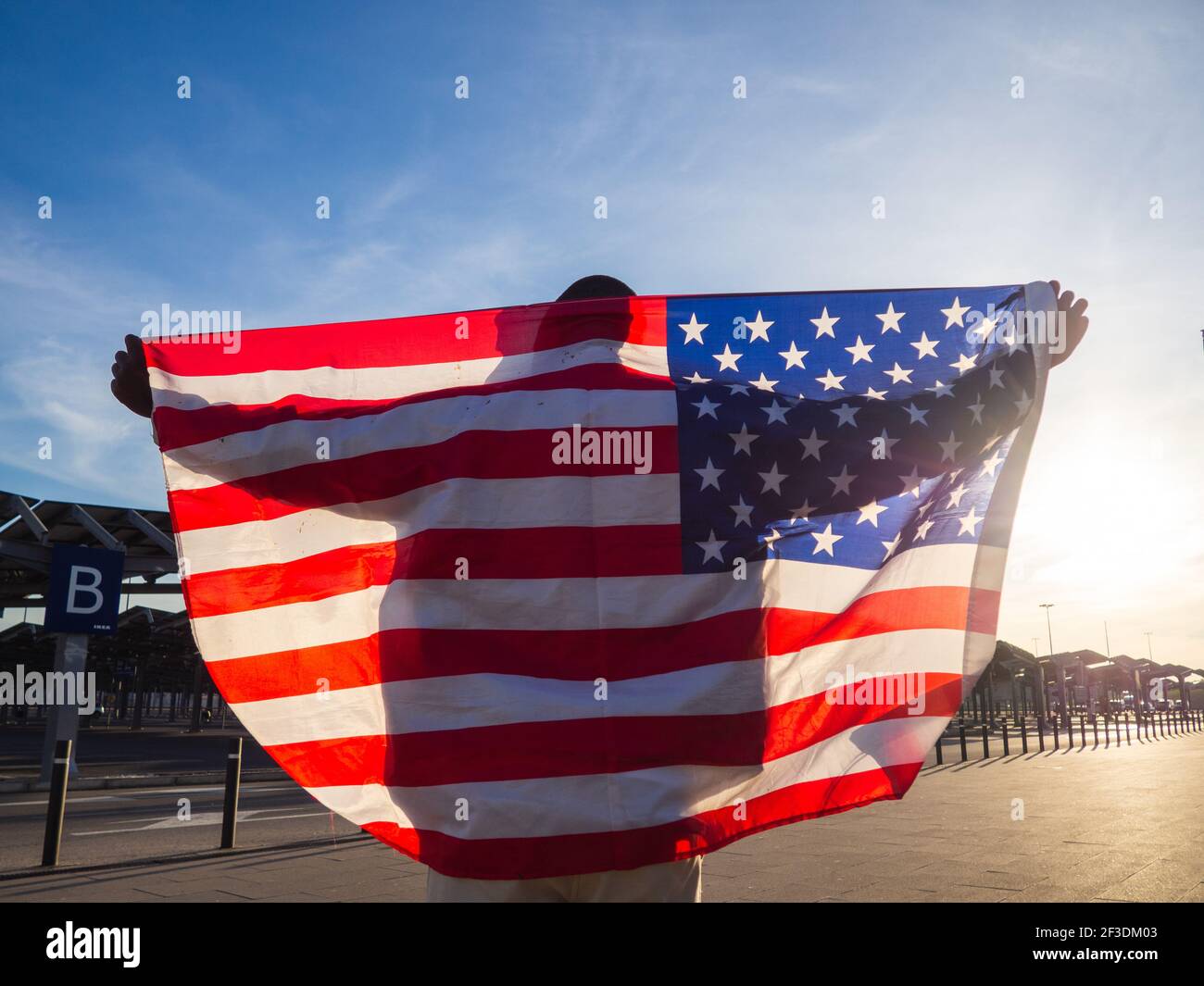 Man holds usa flag behind hi-res stock photography and images - Alamy