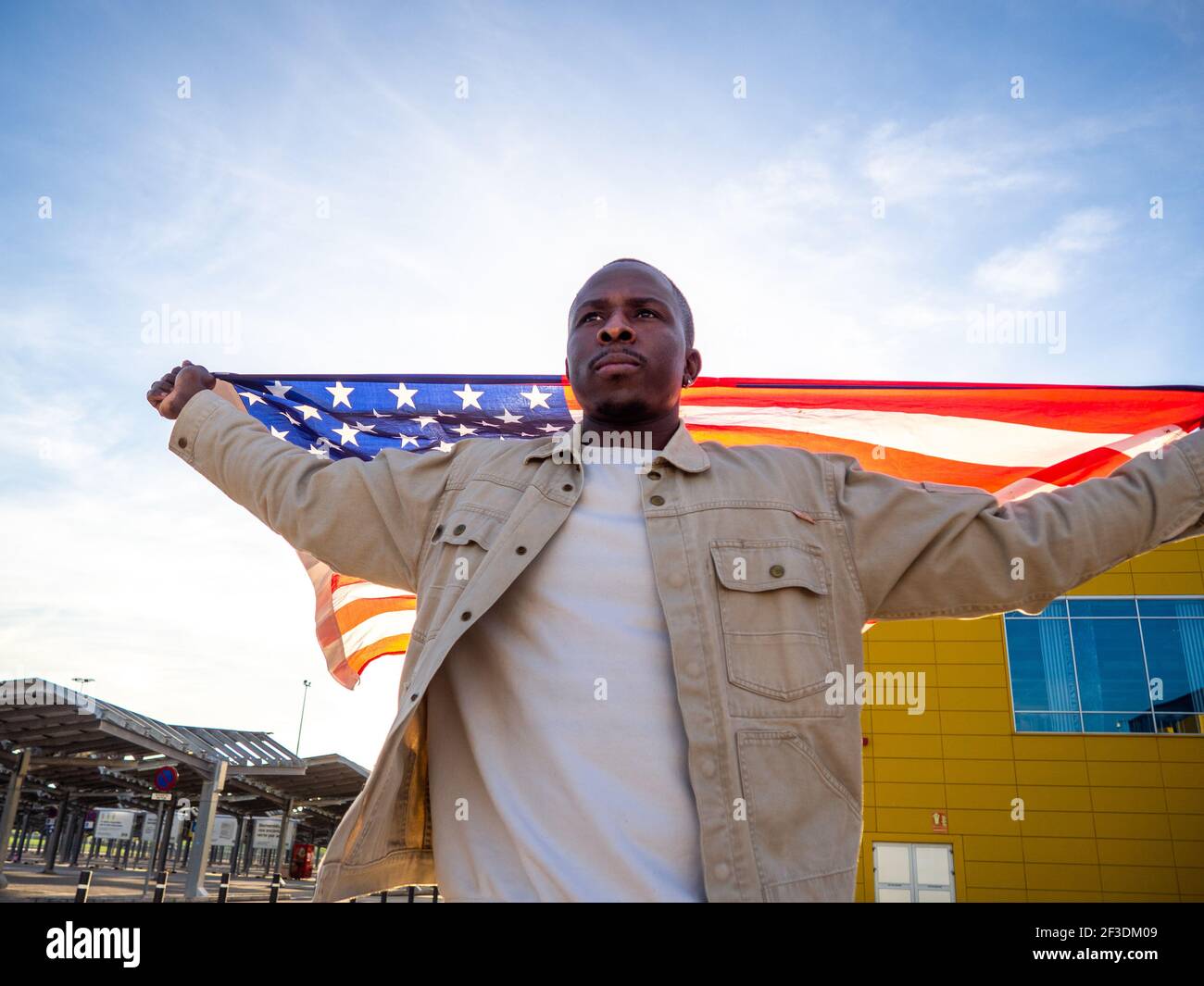Man holds usa flag behind hi-res stock photography and images - Alamy