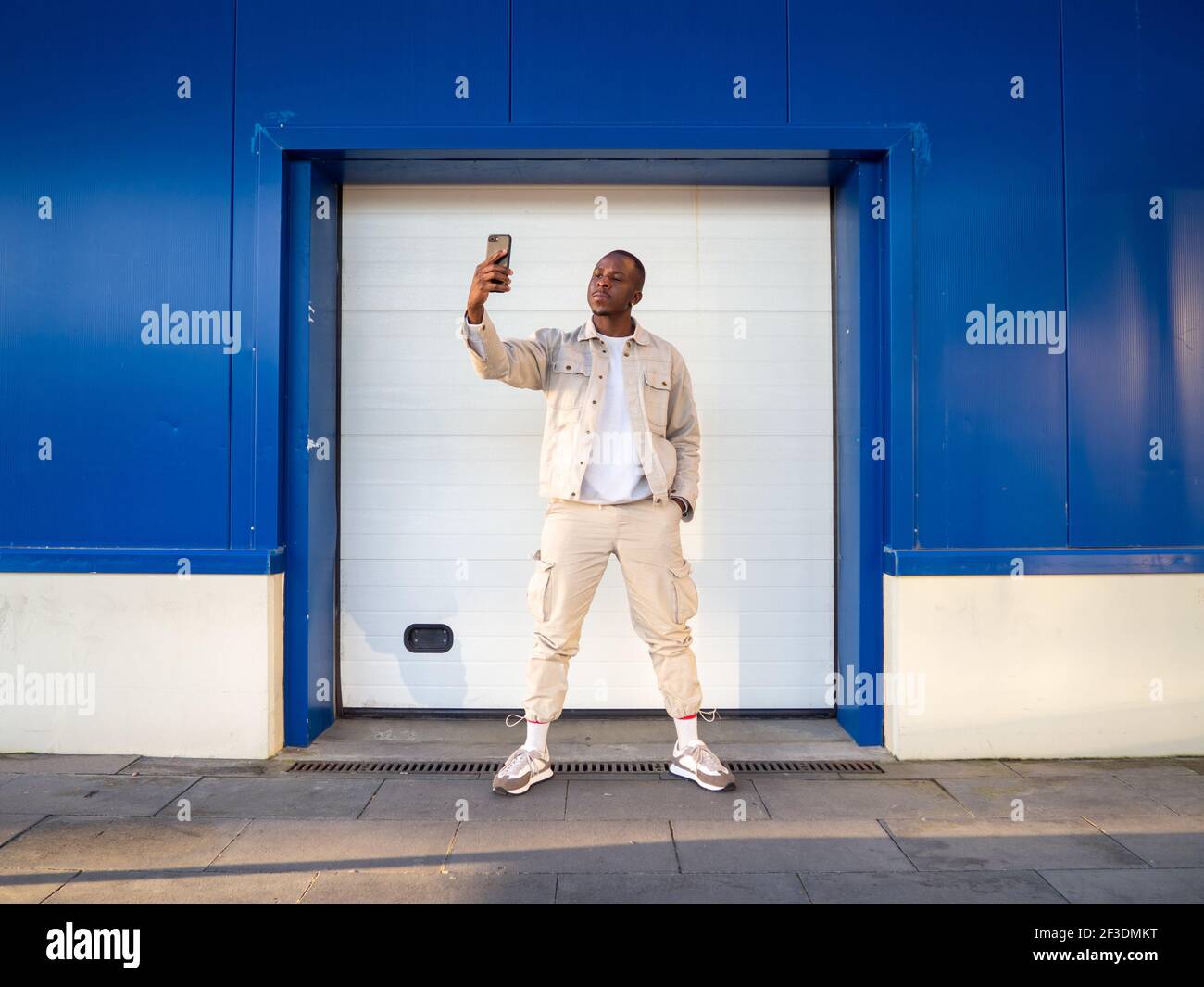 A handsome black Spanish male taking a selfie with his smartphone Stock ...
