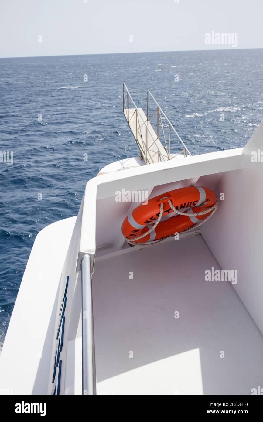 A lifebuoy safety ring attached to the back of a boat in Sardinia Stock ...