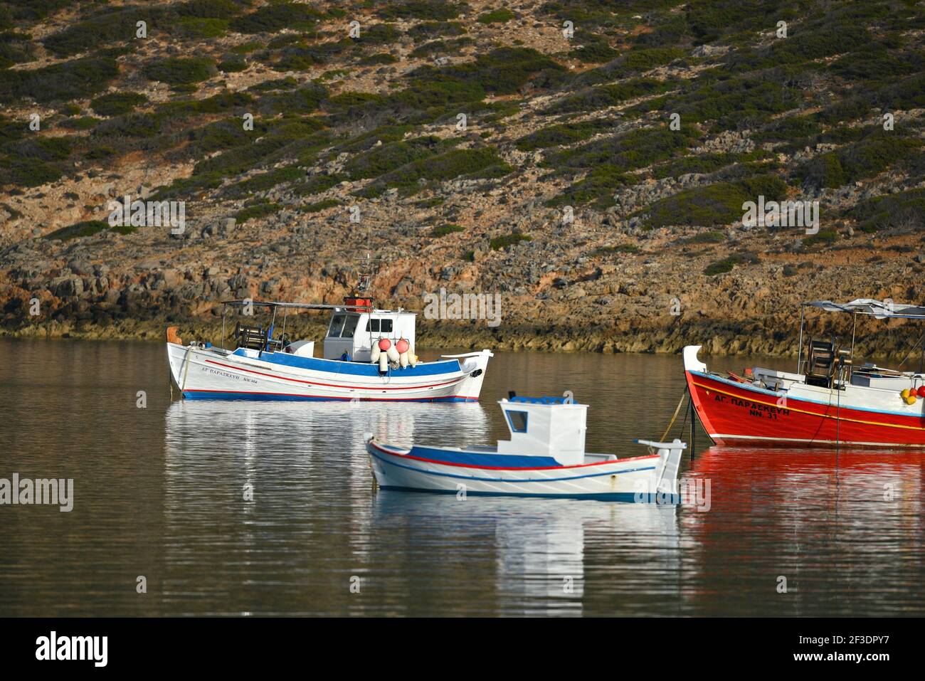 Landscape with traditional wooden Greek fishing boats on the waters of ...