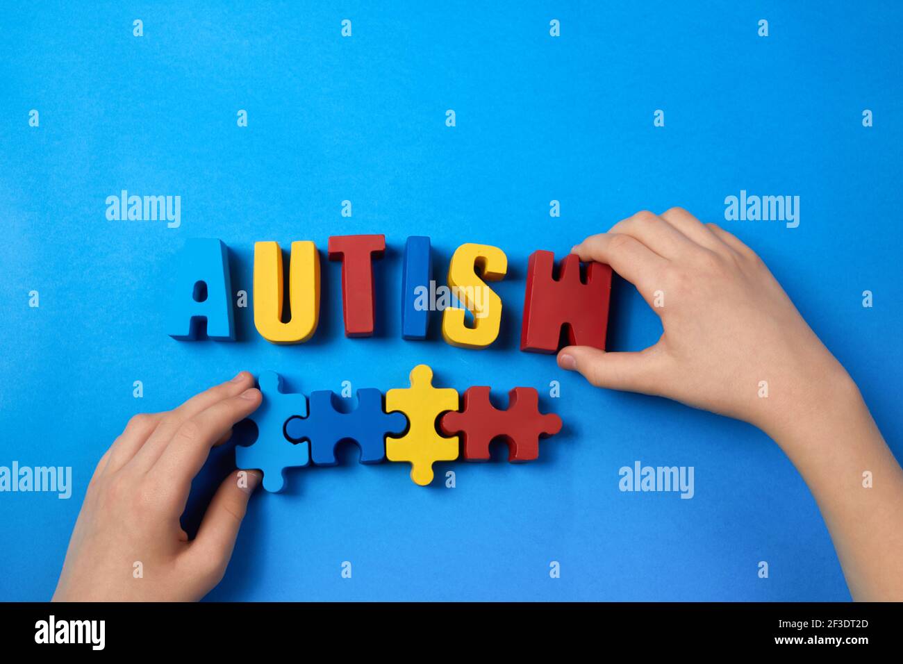 Autistic kid hands holding puzzle jigsaw and word autism, mental health ...