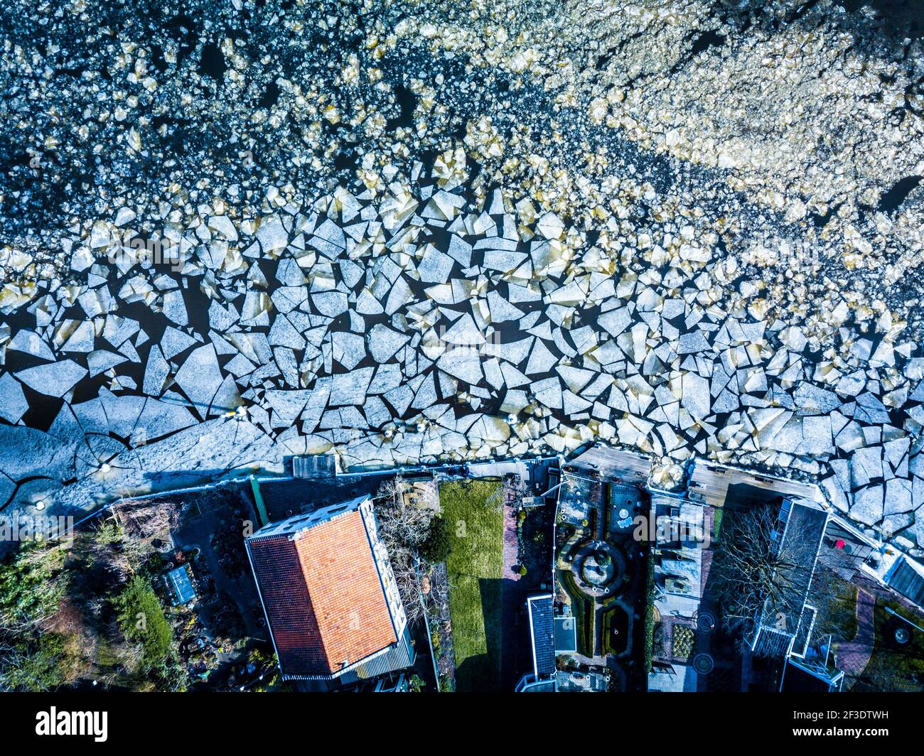 Top down view river surface covered with various size ice floes. Winter ...