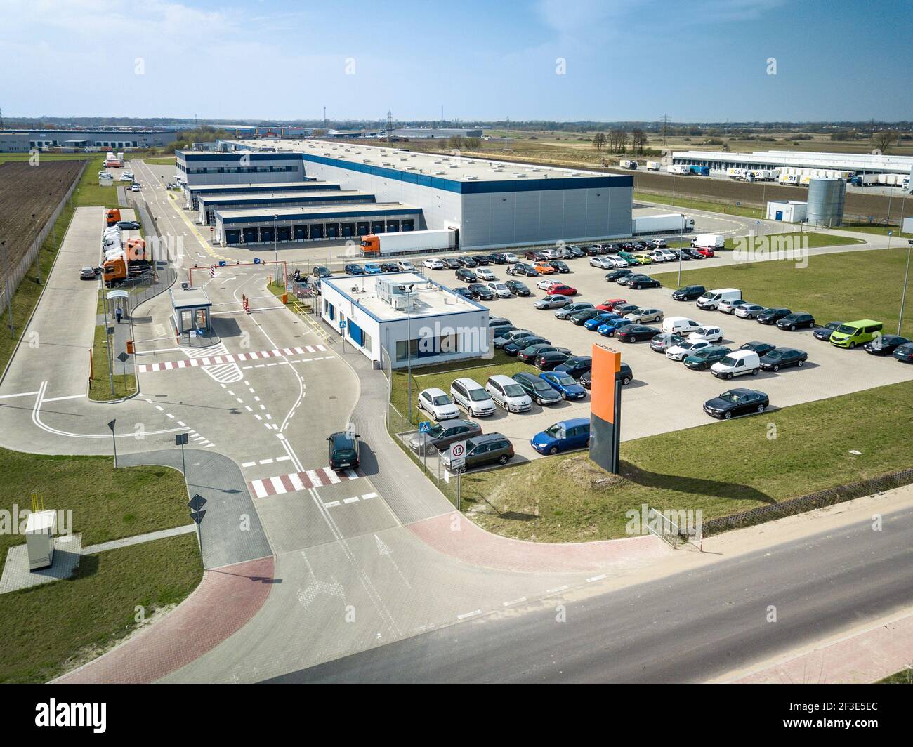 Elevated view of entrance to logistic park. Gatehouse, employee car ...