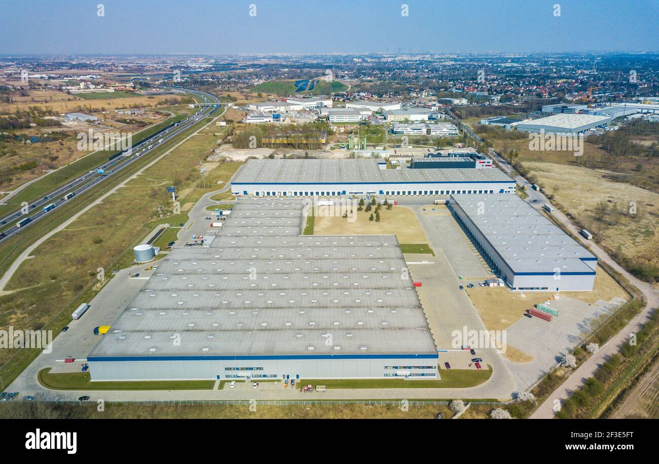 Drone view of large and flat warehouse buildings in logistic park near ...