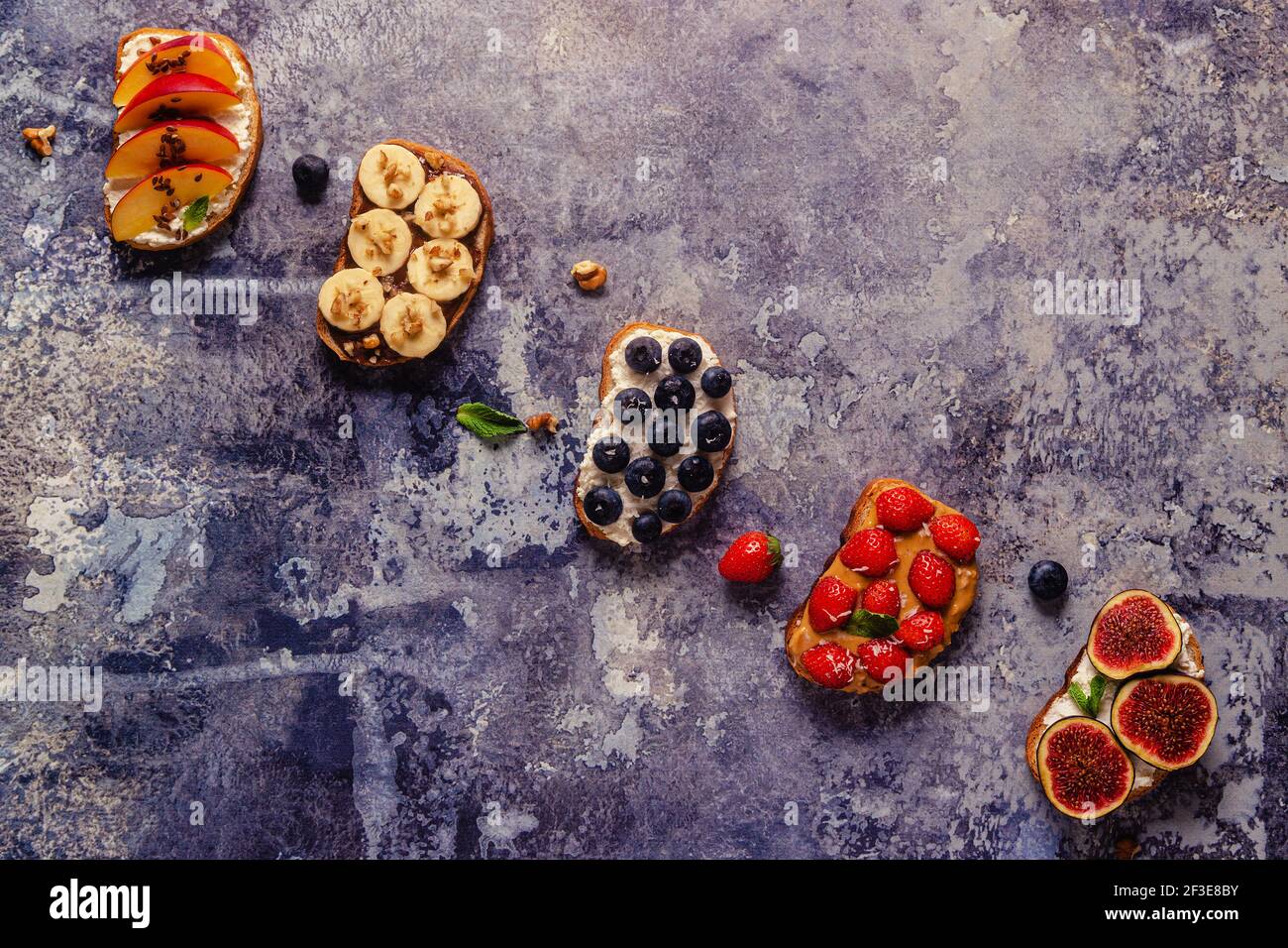 Homemade summer toast with cream cheese, nut butter and fruits and ...