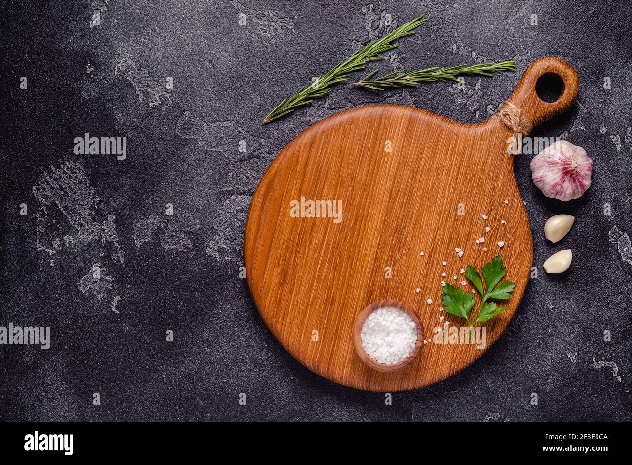 Herbs and condiments on black stone background. Top view with copy ...