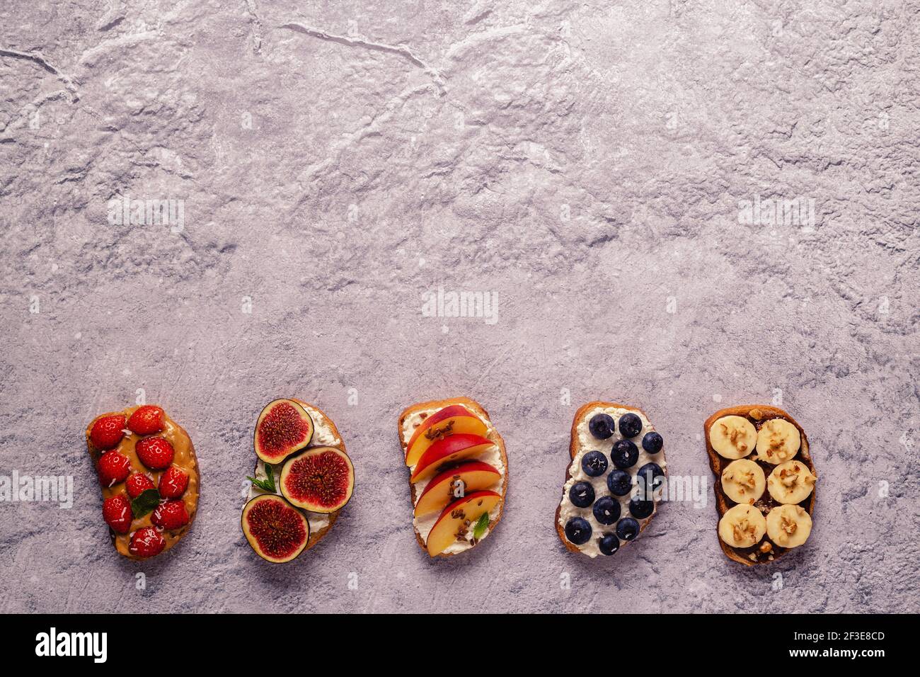 Homemade summer toast with cream cheese, nut butter and fruits and ...