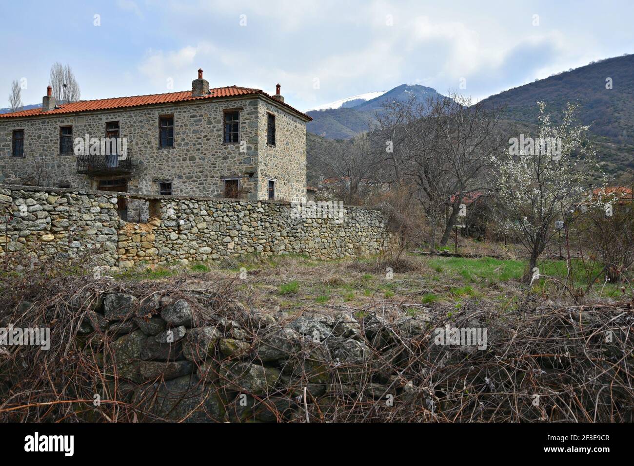 Landscape with a traditional handcrafted rural stone house in the ...