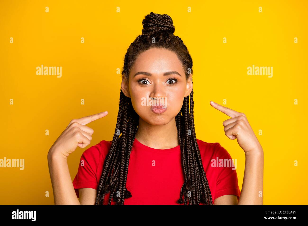 Portrait of pretty funny cheerful girl demonstrating blowing air cheeks ...
