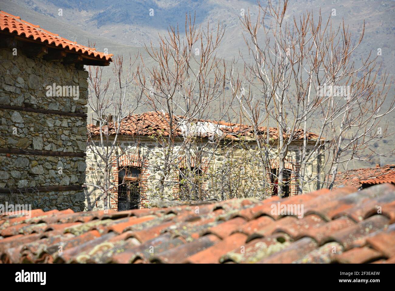 Red clay tile rooftops of traditional handcrafted rural stone houses in ...