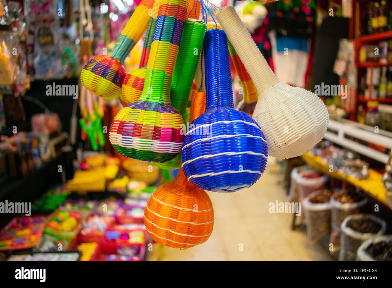 Colorful handmade rattles hanging inside a Mexican market Stock Photo ...