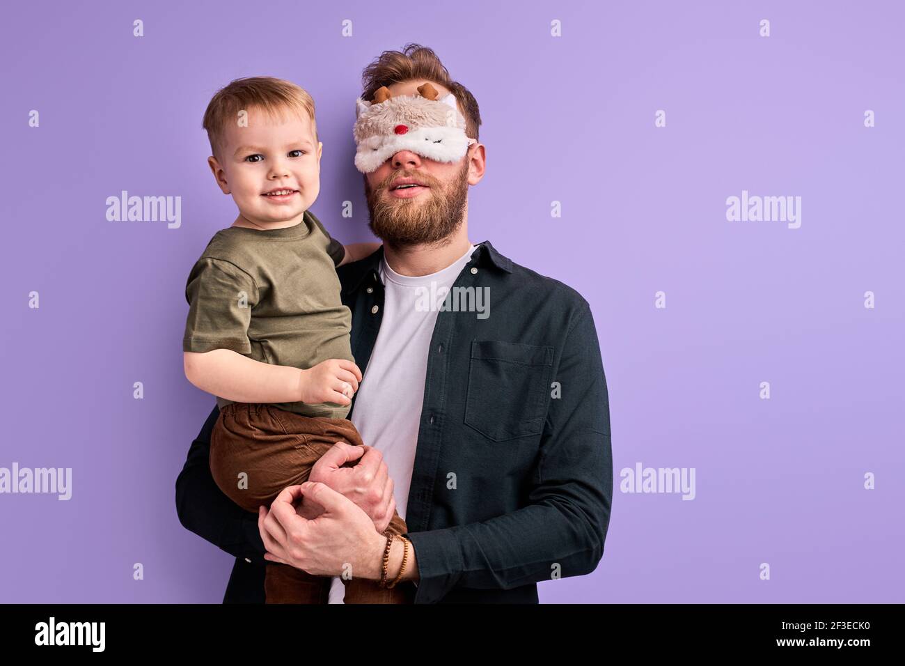 young father in eye mask for sleep doesn't want to take the child to ...