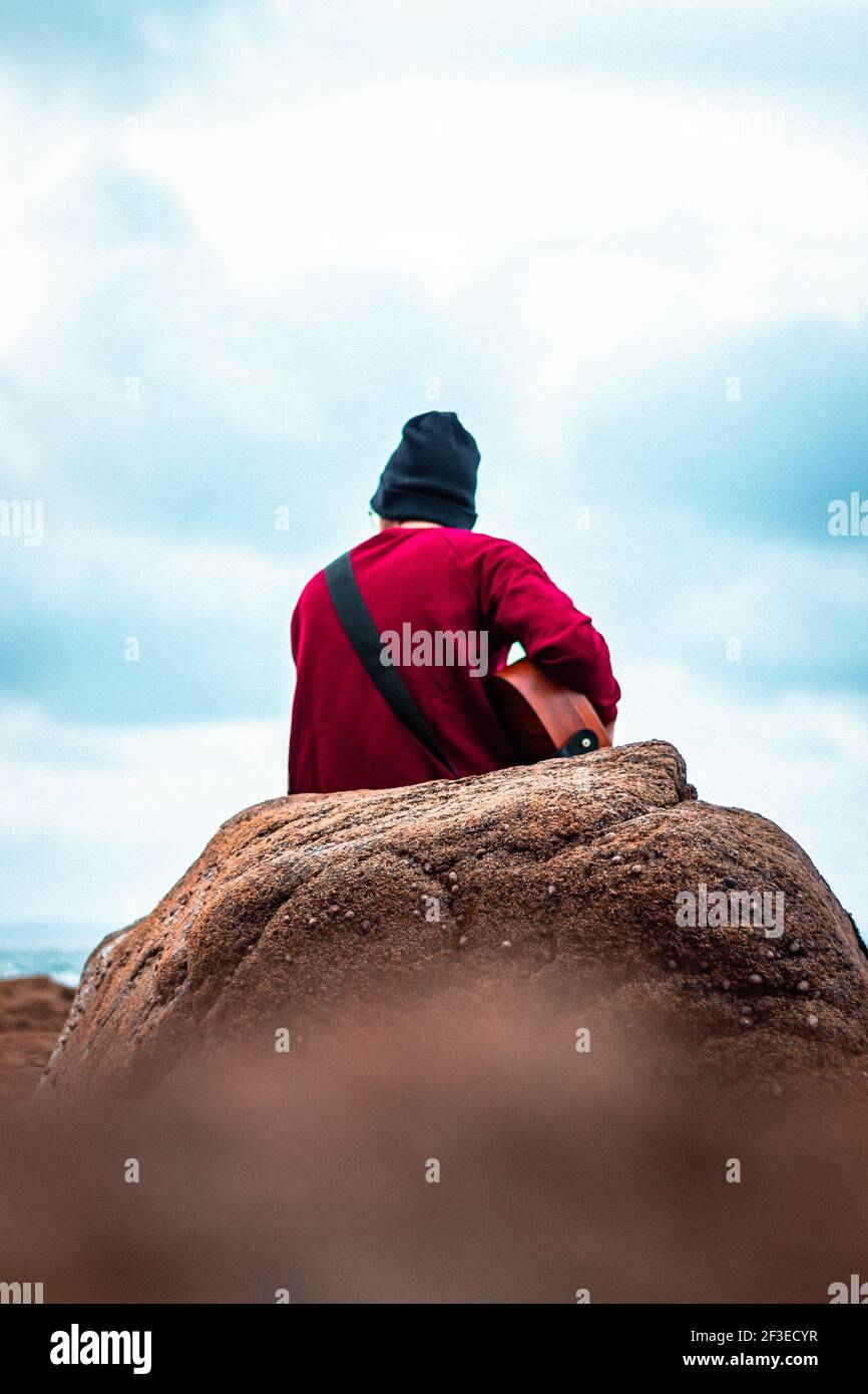 A back view of a male playing acoustic guitar Stock Photo - Alamy