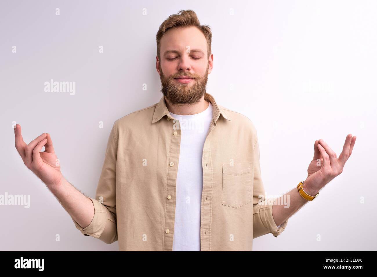 calm male meditating in yoga pose standing with eyes closed. isolated ...