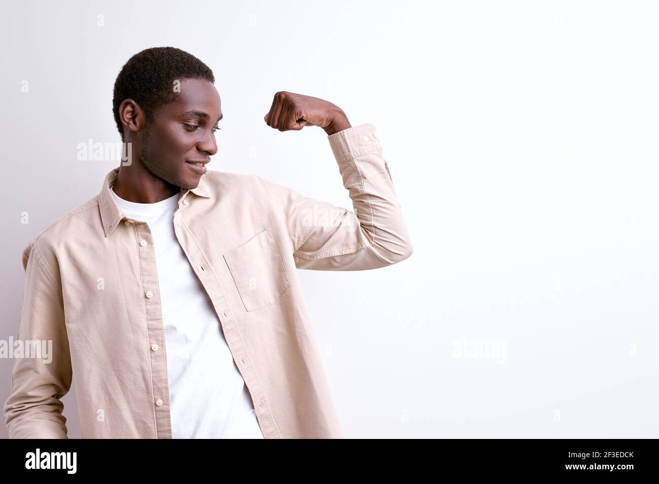 afro american guy showing arm muscles, powerful strong man isolated on ...