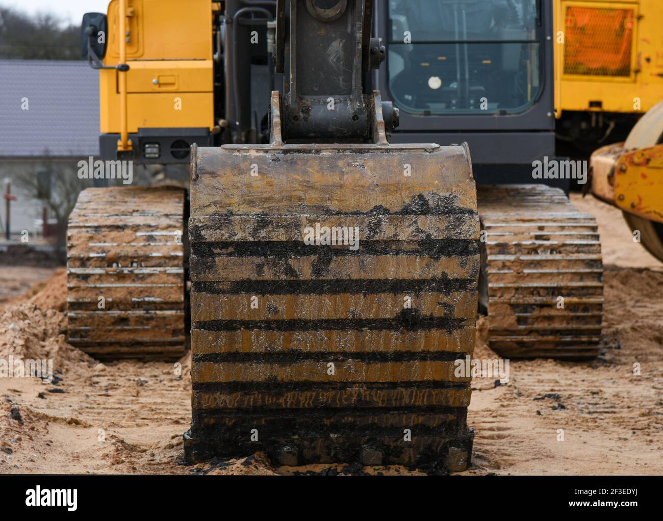 Yellow excavator bucket on the sand Stock Photo - Alamy