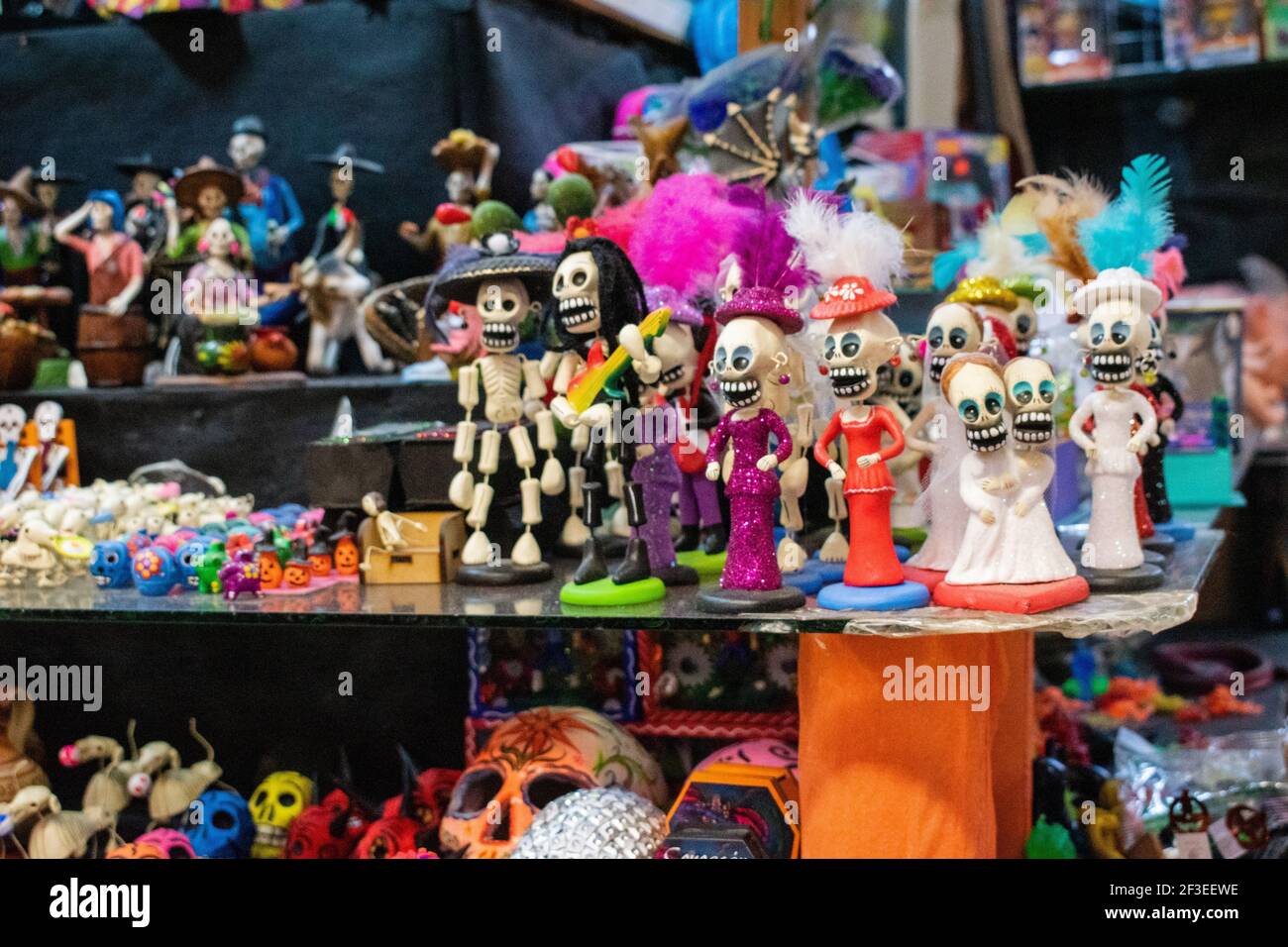 Colorful handmade skeleton figures displayed on black surface Stock ...