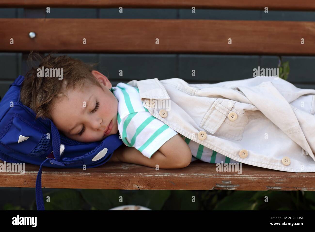 Boy sleeping on bench hi-res stock photography and images - Alamy