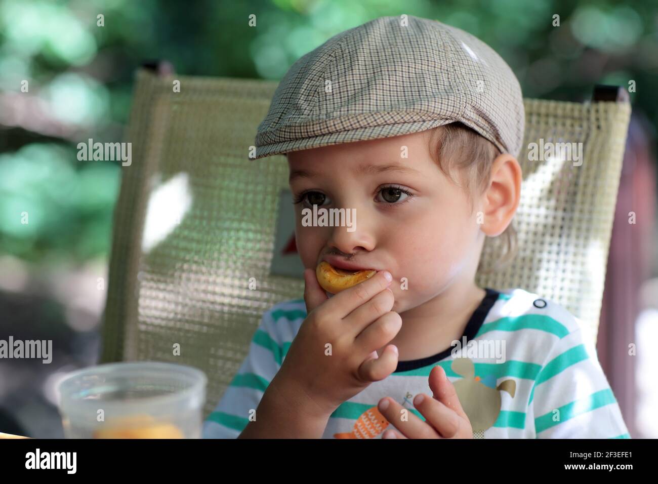 Boy biting peach hi-res stock photography and images - Alamy