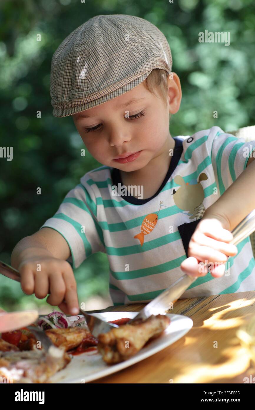 Child eating chicken in the outdoor cafe Stock Photo - Alamy