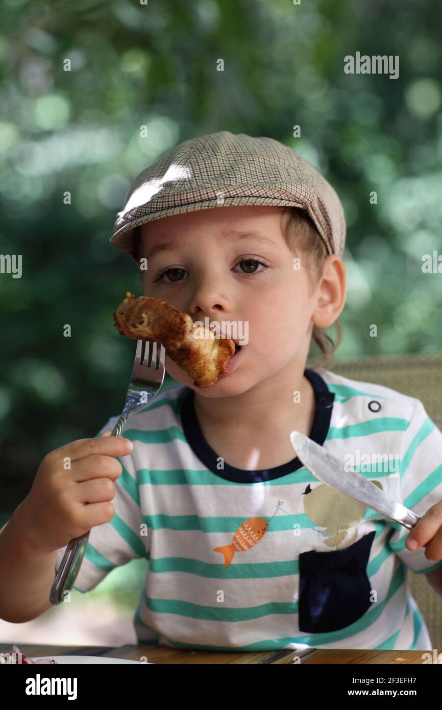 Boy eating chicken leg hi-res stock photography and images - Alamy