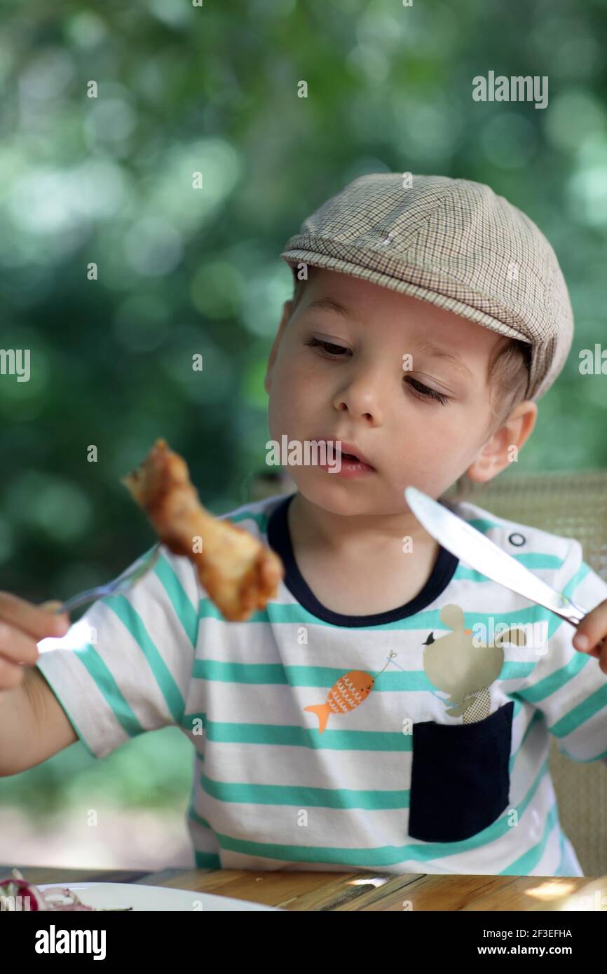 Boy eating chicken leg hi-res stock photography and images - Alamy