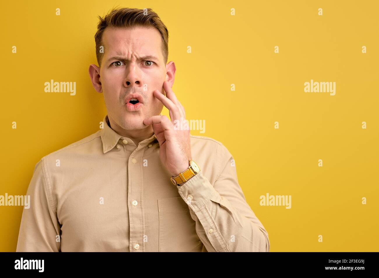 shocked man stand with wide opened mouth and eyes, looking at camera ...