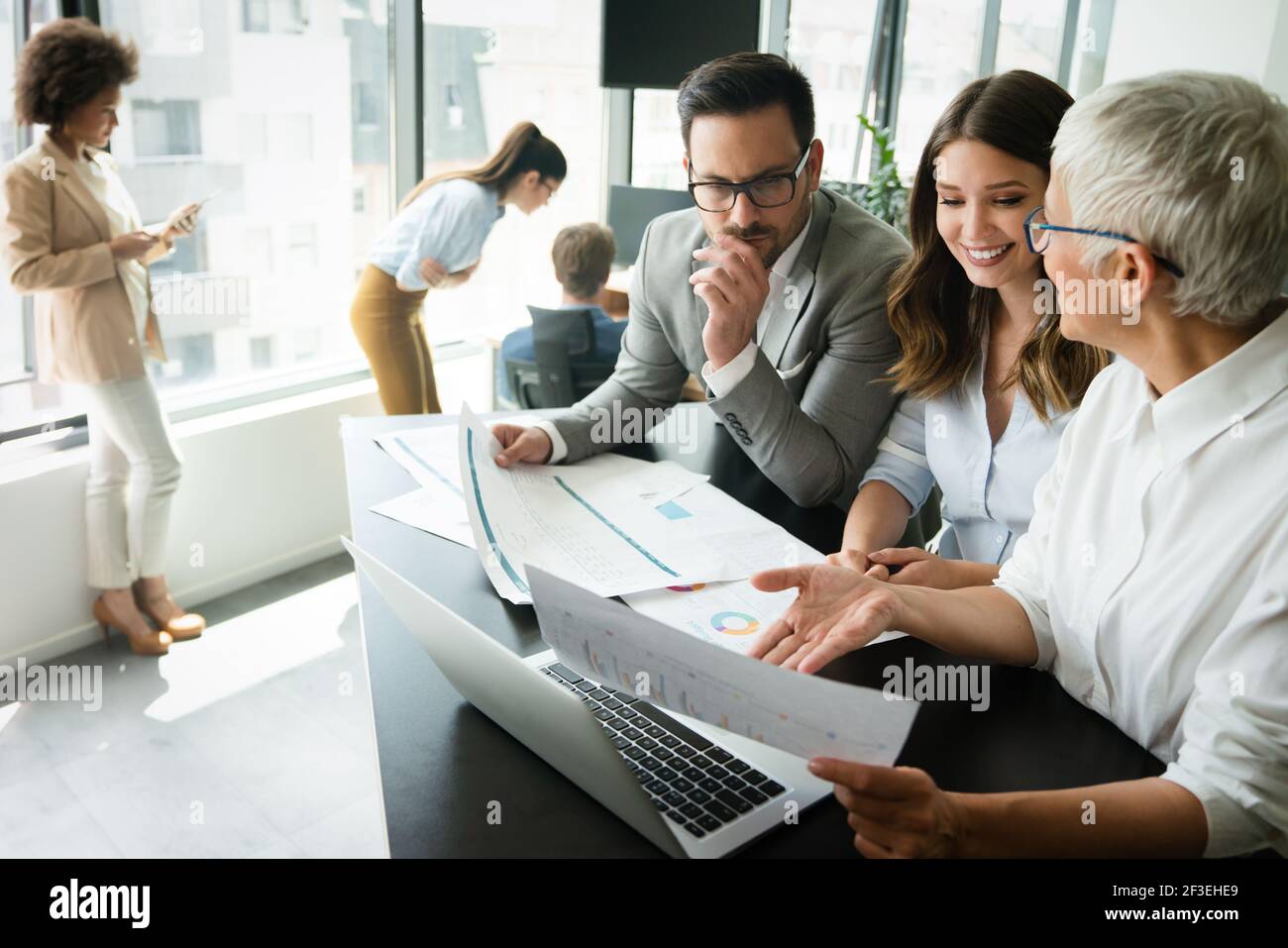 Happy business people having fun and chatting at workplace office Stock ...