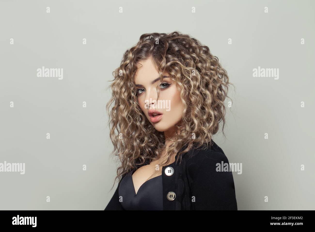 Perfect woman with curly hairstyle on white background Stock Photo - Alamy