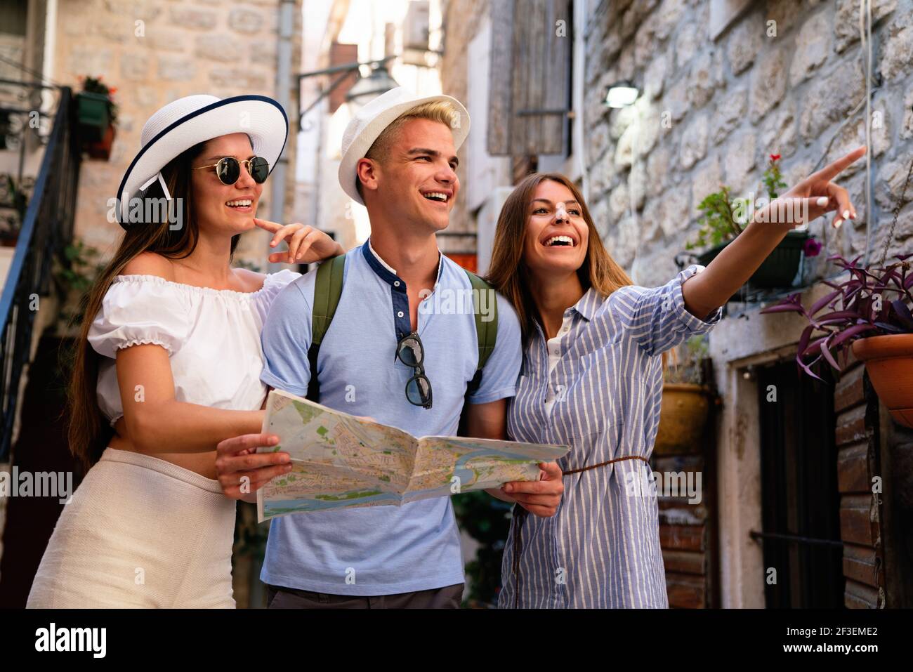 Happy group of friends tourists sightseeing in city on vacation Stock ...