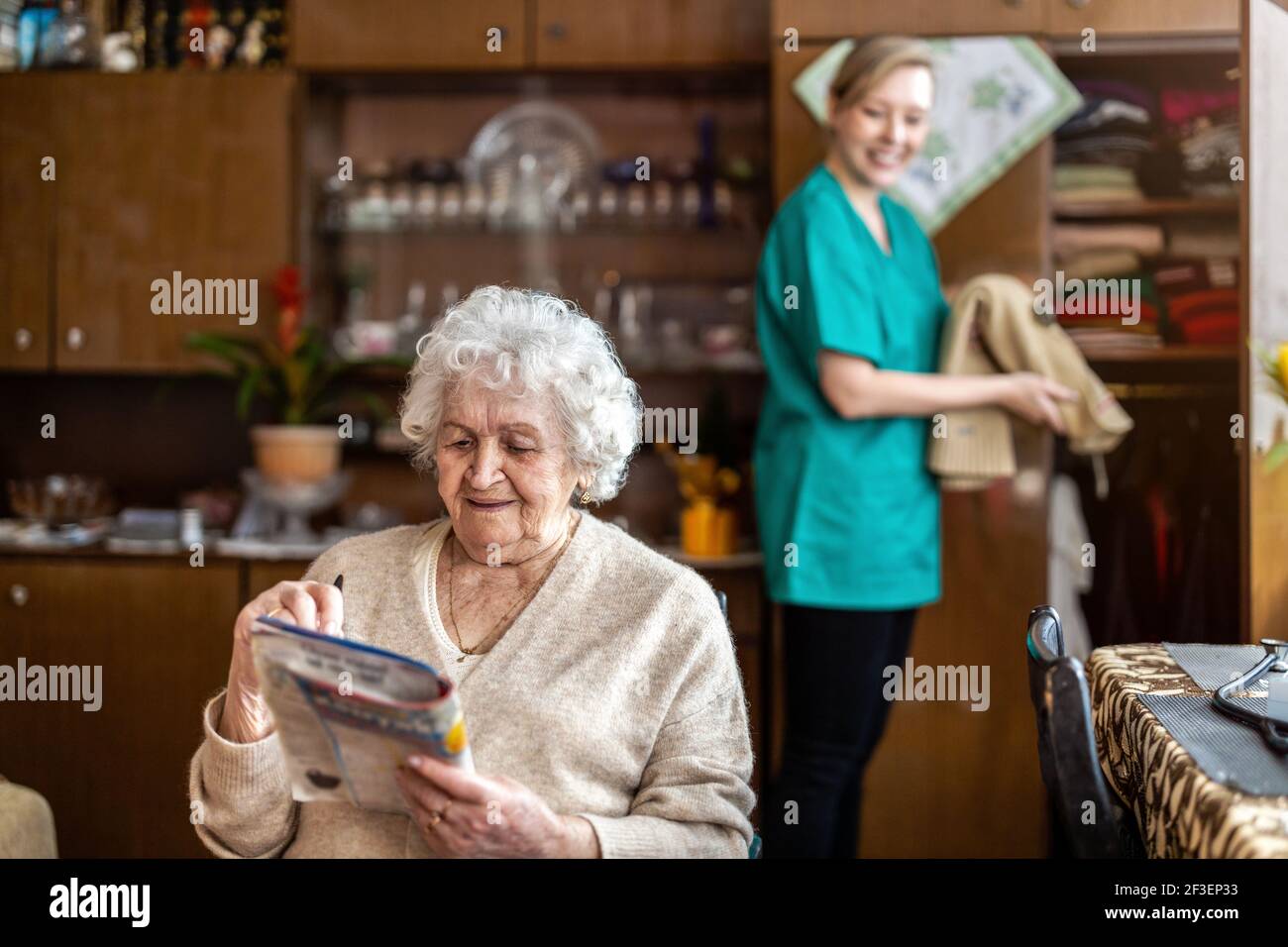Friendly nurse supporting an elderly lady Stock Photo - Alamy